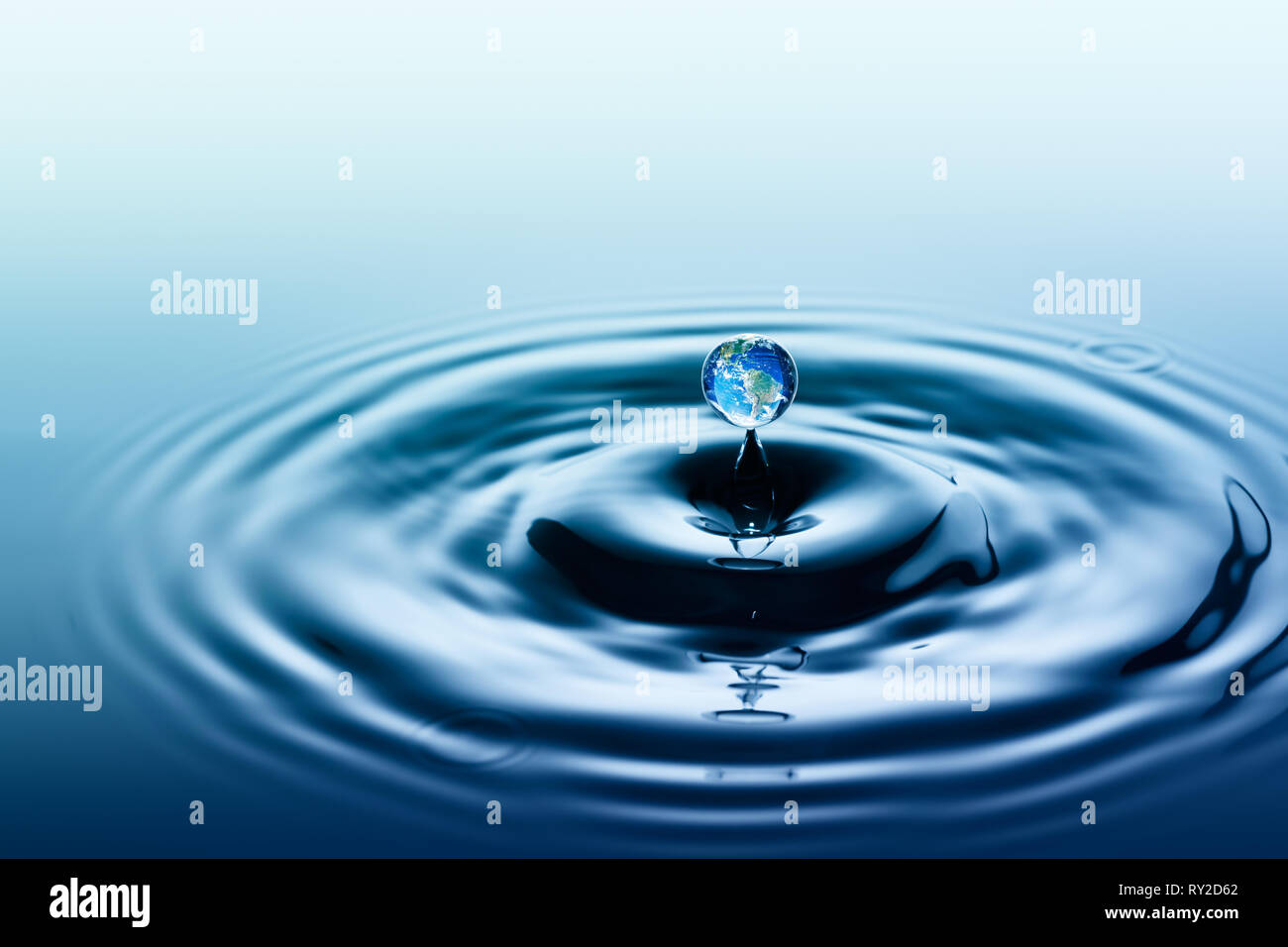 Drop of rain with earth image falling on smooth water surface Stock ...