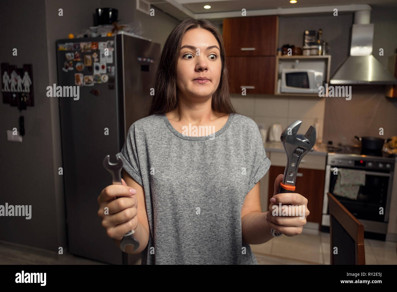young woman locksmith holding spanners, gender equality concept Stock ...