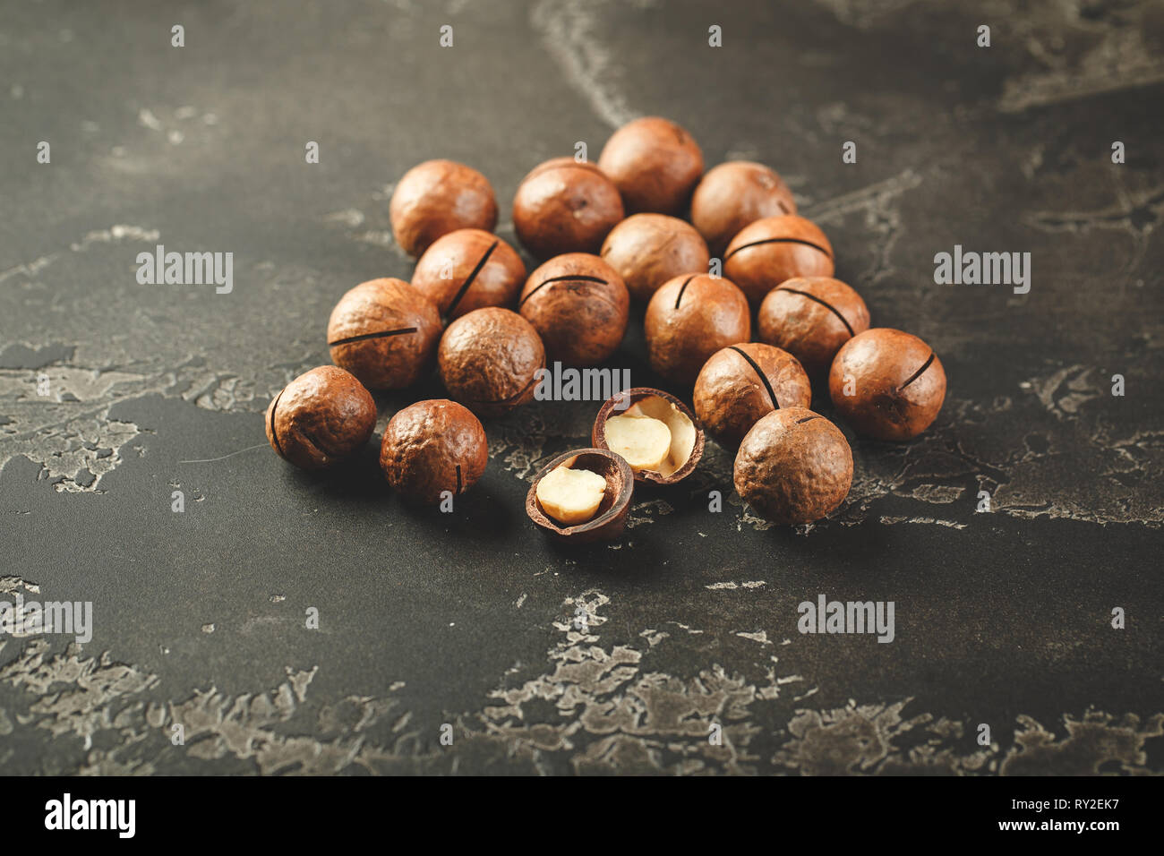 Organic Macadamia nuts in on dark cocrete background close up Stock ...