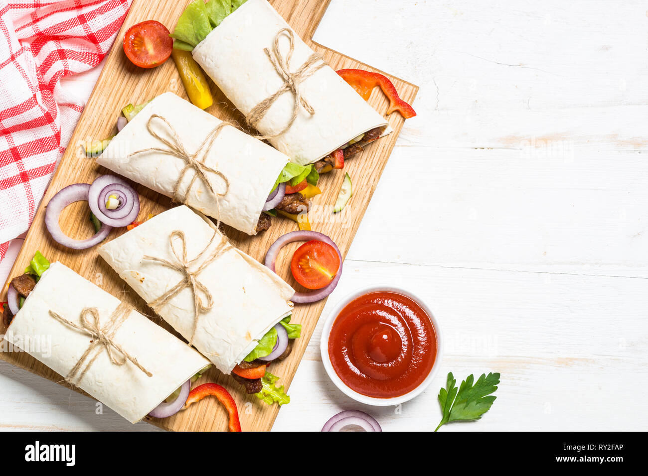 Burritos tortilla wraps with beef and vegetables on white Stock Photo ...