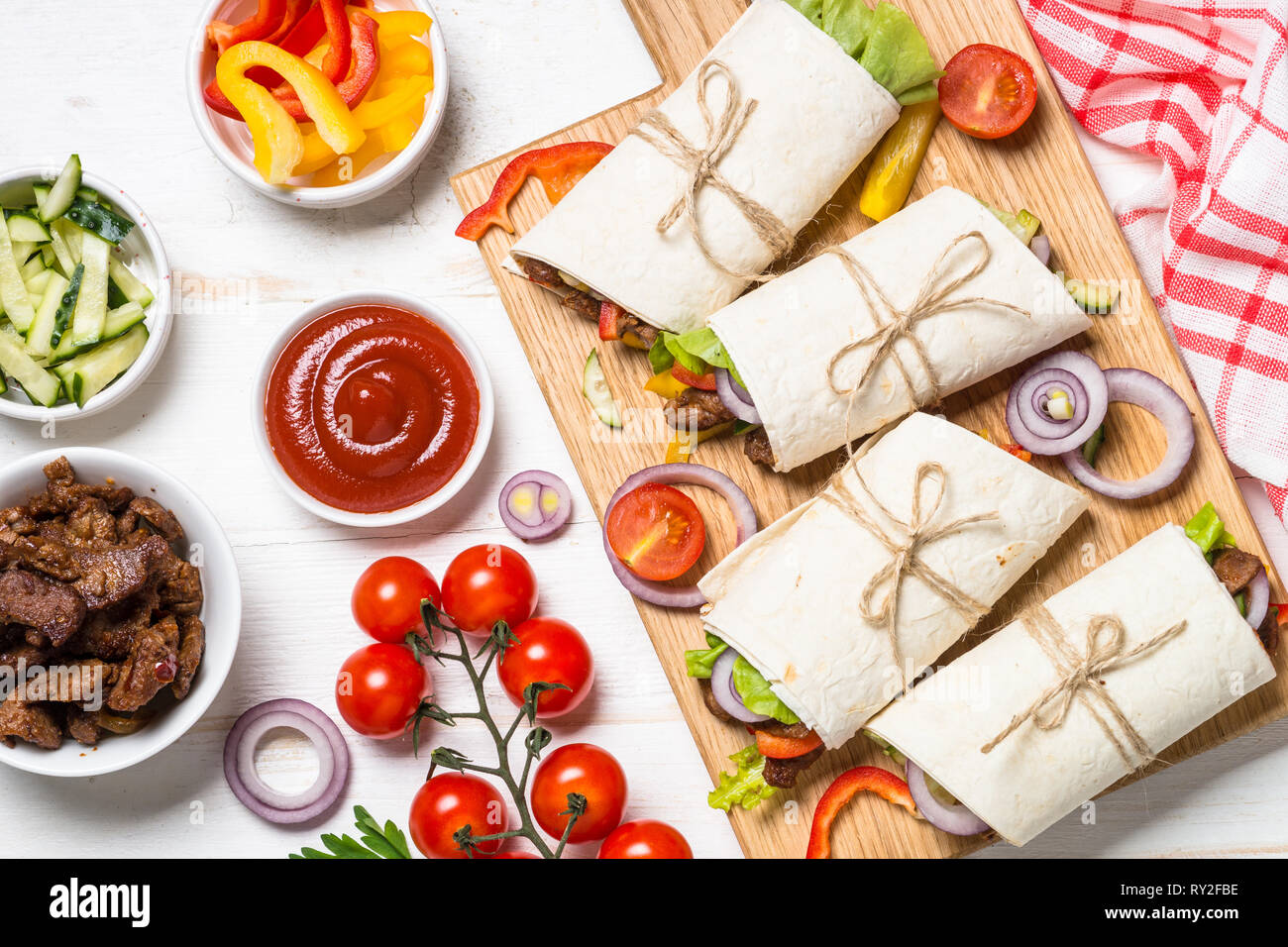 Burritos tortilla wraps with beef and vegetables on white Stock Photo ...