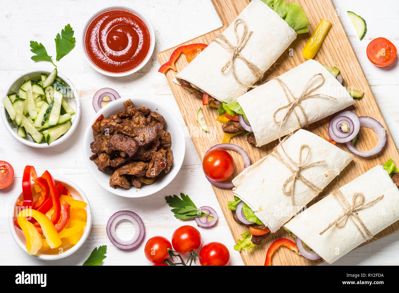 Burritos tortilla wraps with beef and vegetables on white Stock Photo ...