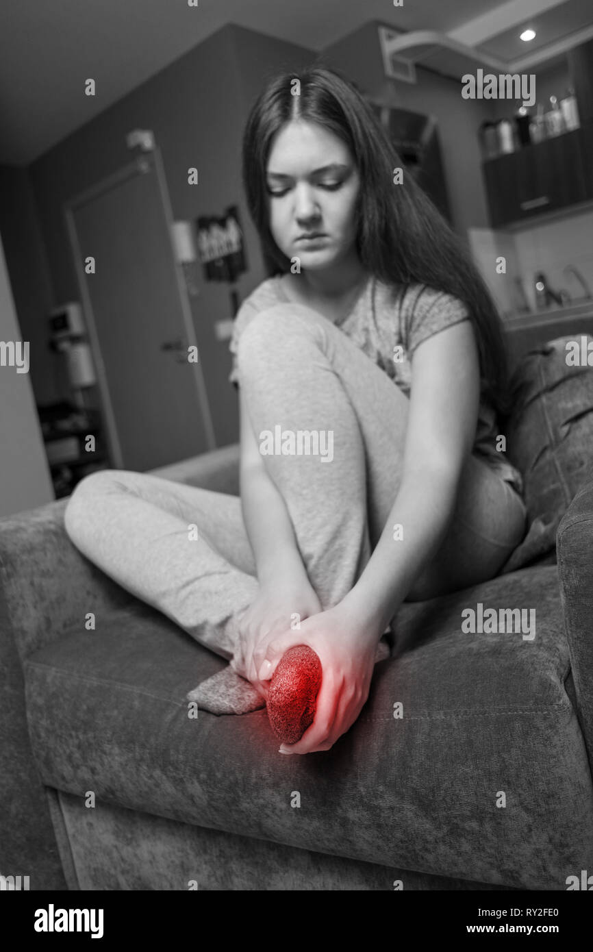 pain in foot, girl holds her feet, foot massage, cramp, muscular spasm ...
