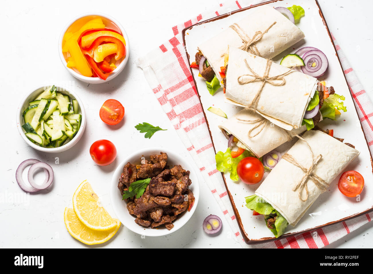 Burritos tortilla wraps with beef and vegetables on white Stock Photo ...