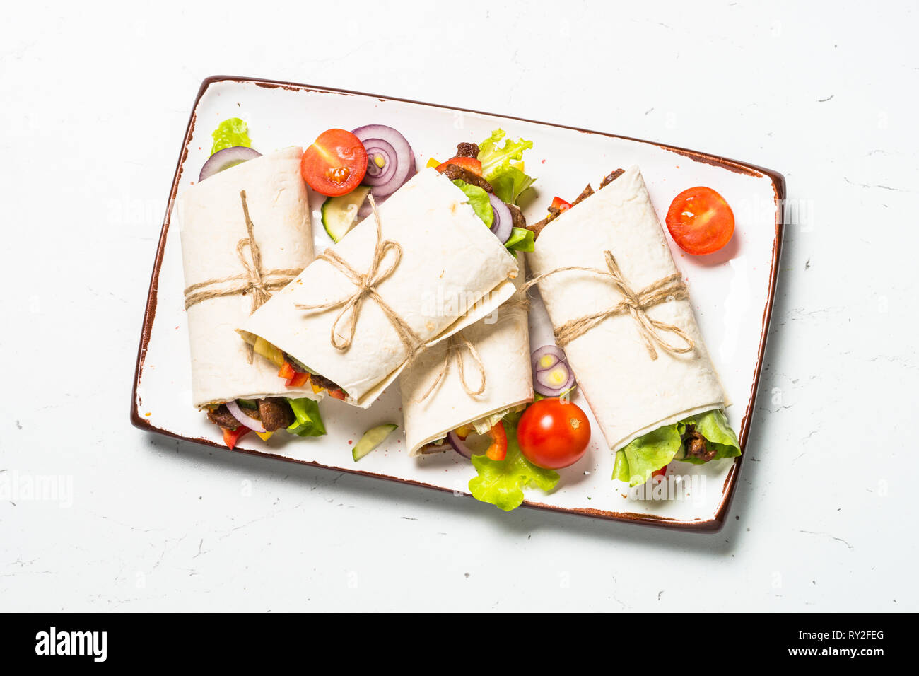 Burritos tortilla wraps with beef and vegetables on white Stock Photo ...