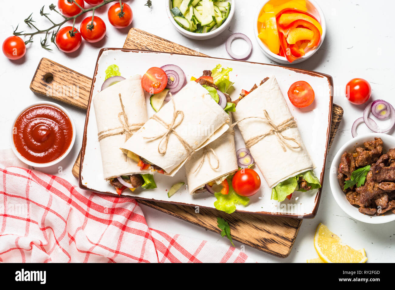 Burritos tortilla wraps with beef and vegetables on white Stock Photo ...
