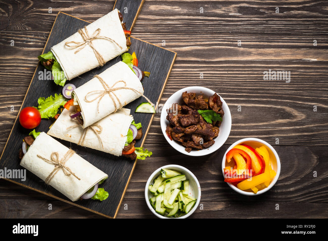 Burritos tortilla wraps with beef and vegetables top view Stock Photo ...