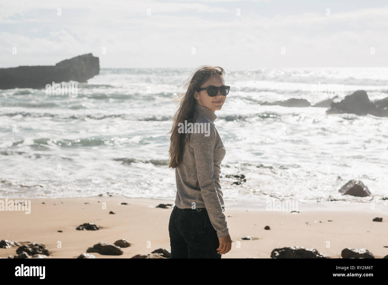Portrait of a beautiful young girl in sunglasses on the coast of the ...
