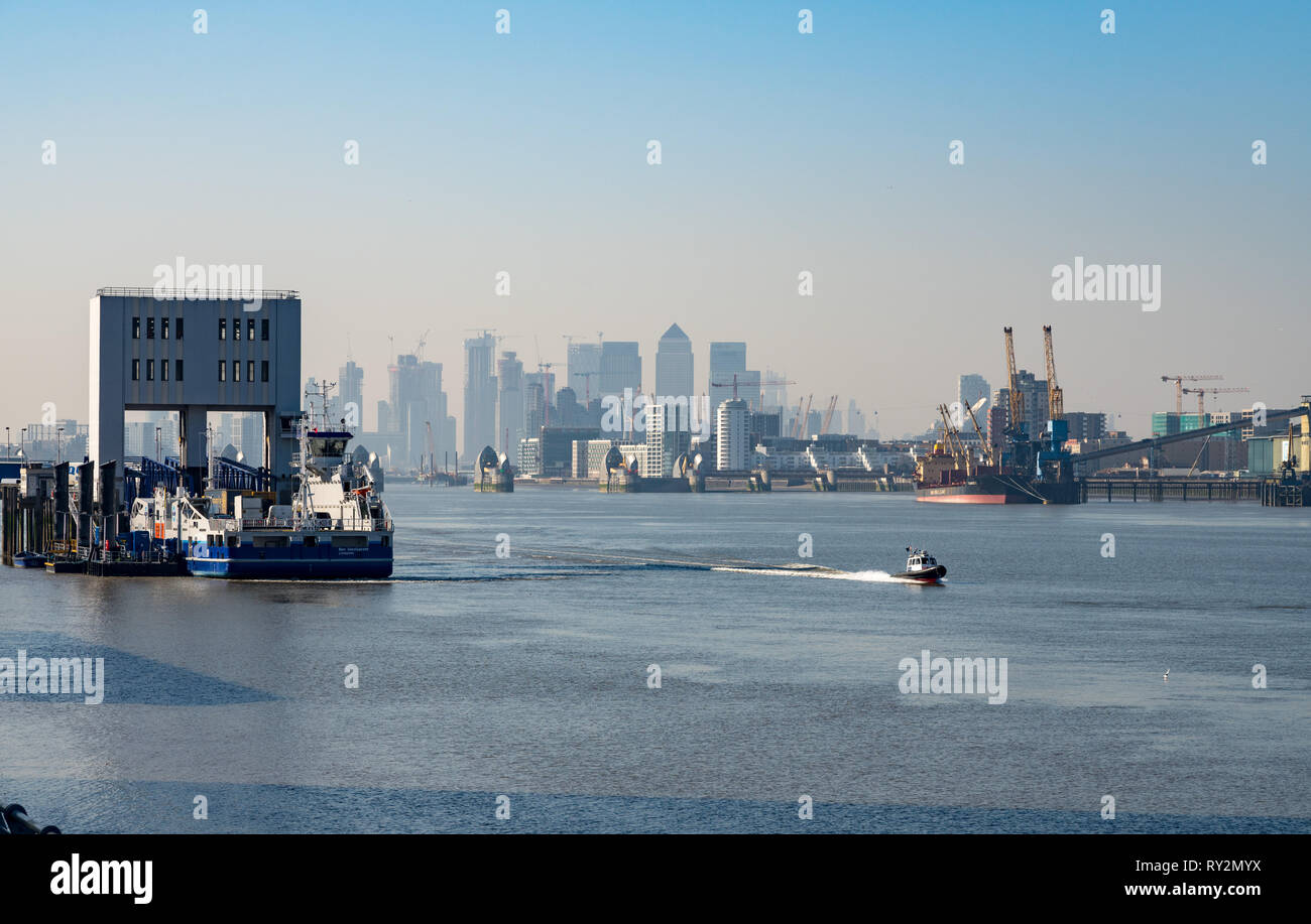 Woolwich Ferry across River Thames with Canary Wharf in background ...
