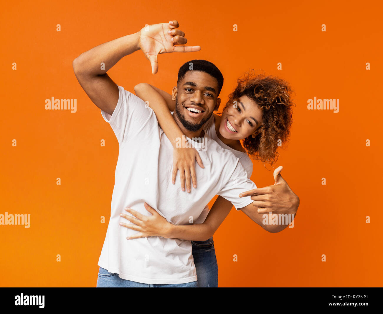 Couple having fun taking picture with imaginary camera Stock Photo - Alamy
