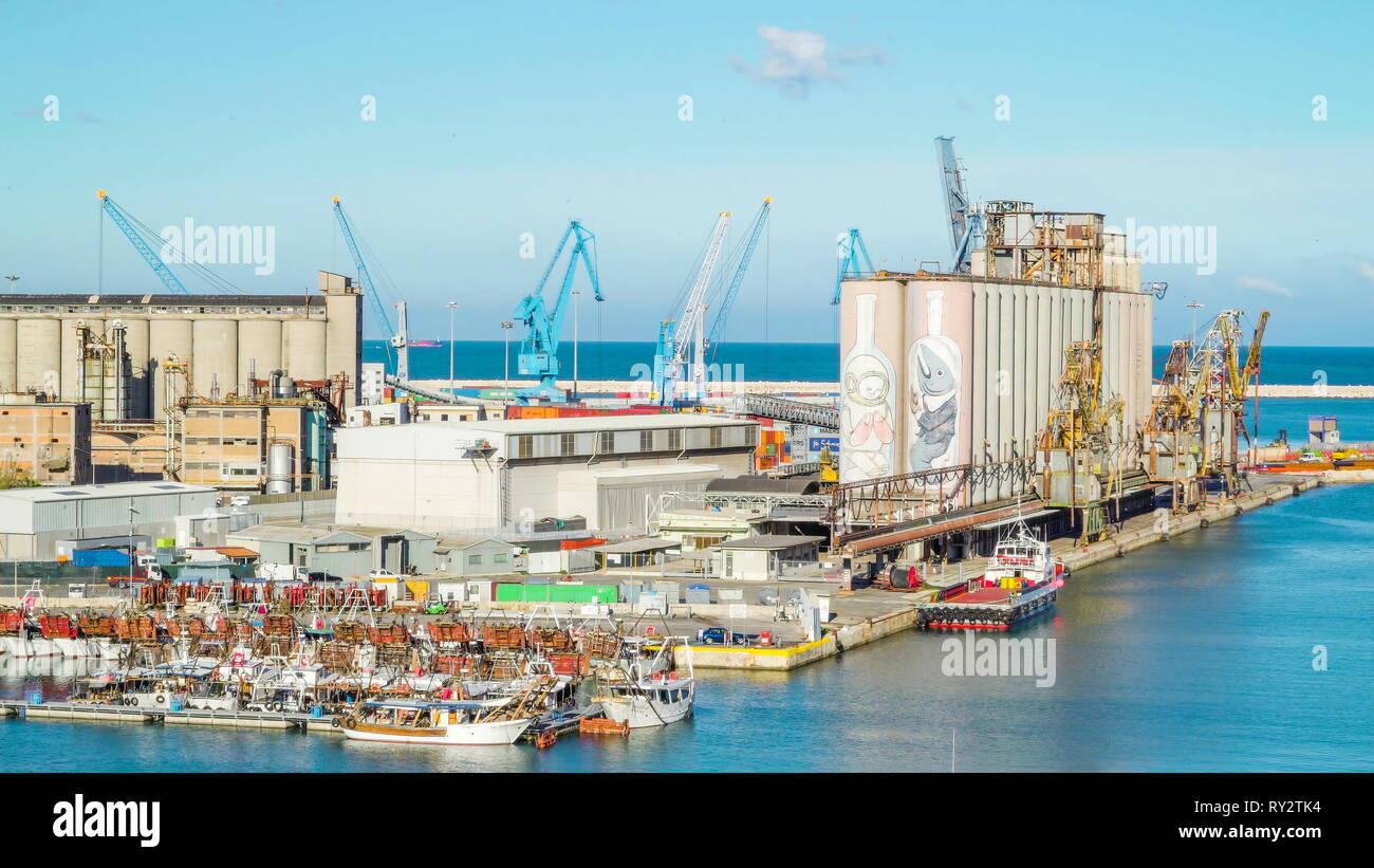 An industrial plant on the sea in Ancona Italy with lots of cranes used ...