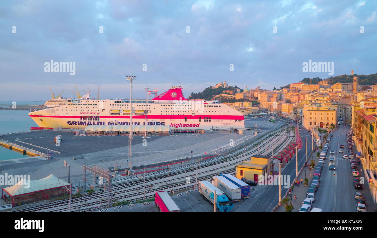 A big white ferry ship on the port of Ancona and the view of a tower ...