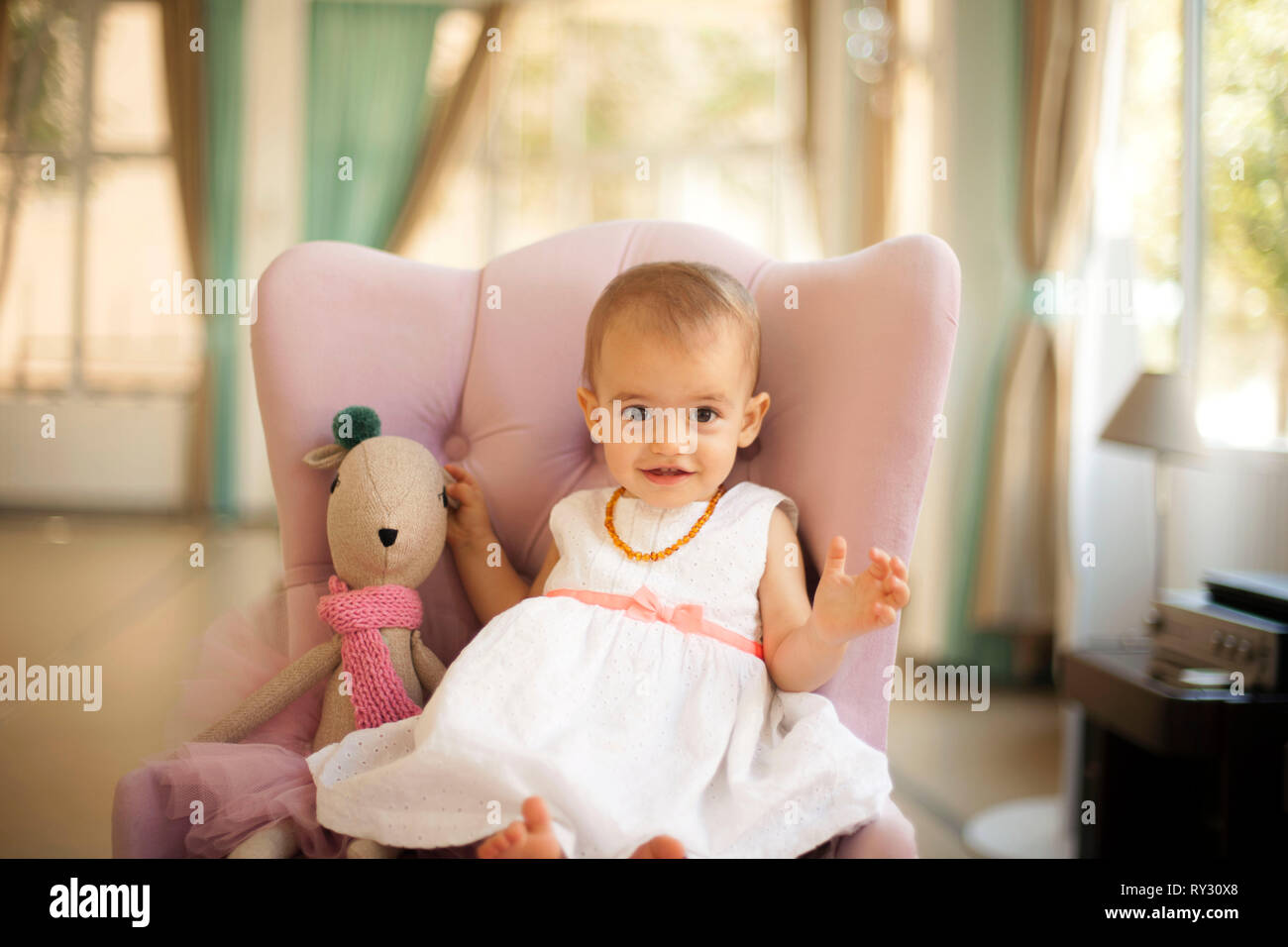 Cute adorable baby girl playing with first doll Stock Photo - Alamy
