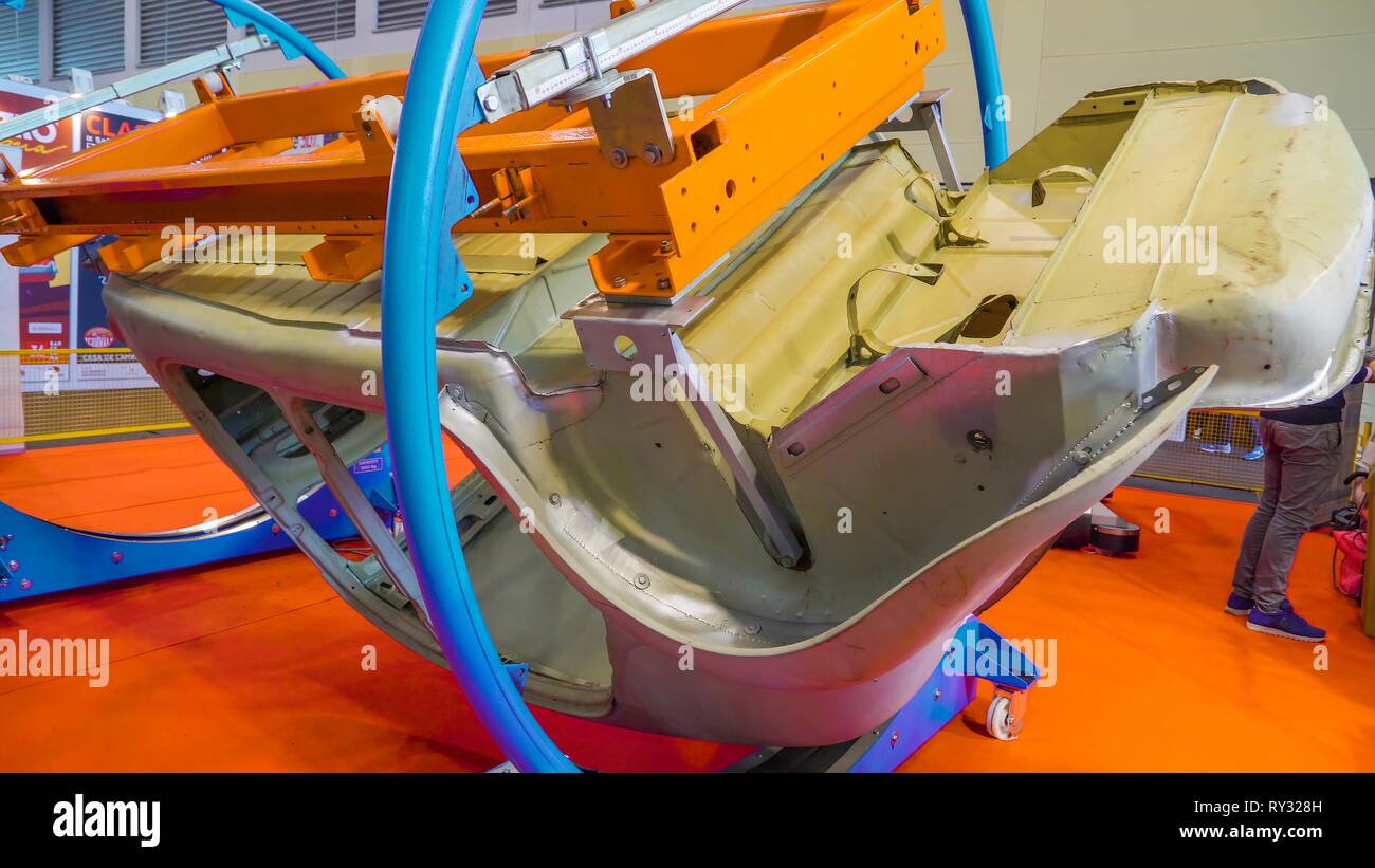 A skeleton part of a car being turned around inside a display in the ...