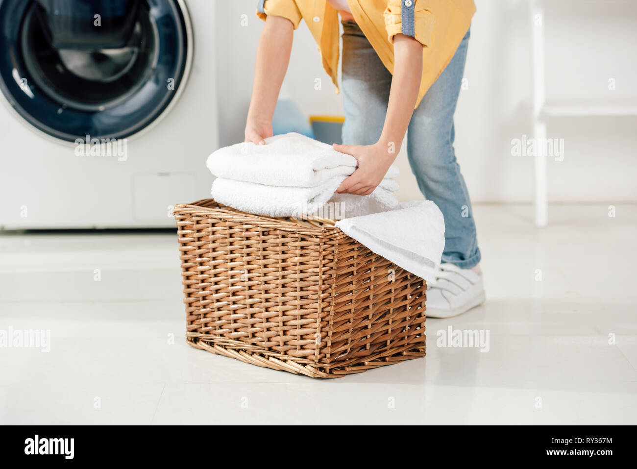 Child putting clothes washing machine hi-res stock photography and ...