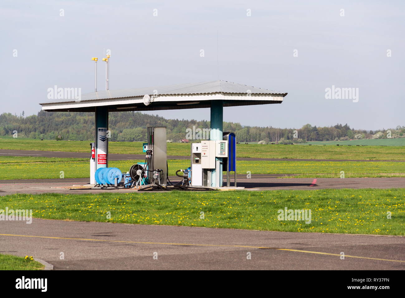 Aviation fuel filling station on airport with airfield runway in ...
