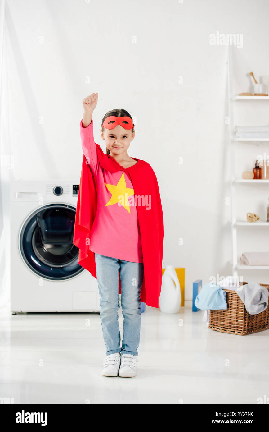 child in red homemade superhero suit in laundry room Stock Photo - Alamy