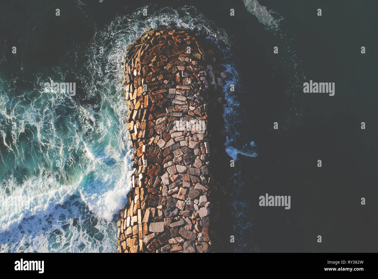 Aerial top view from a stone Jetty. Drone photo Stock Photo - Alamy