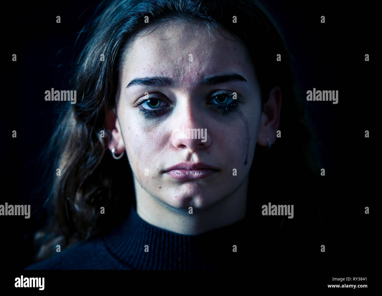 Closeup of a bullied, depressed, alone, tired, stressed young child ...