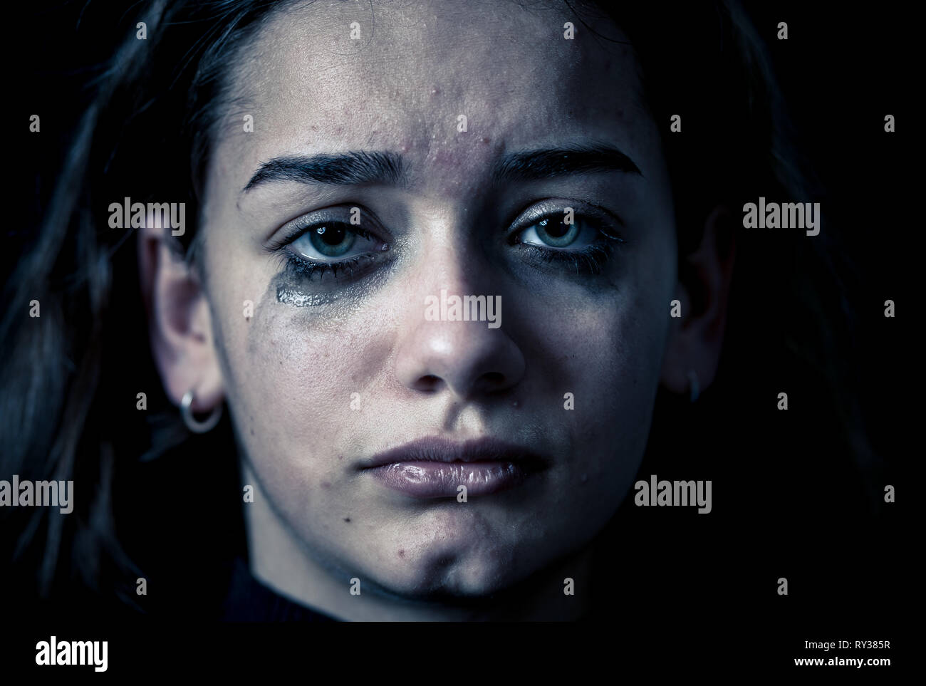 Closeup of a bullied, depressed, alone, tired, stressed young child ...