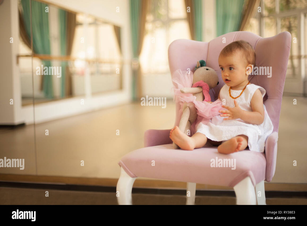 Cute adorable baby girl playing with first doll Stock Photo - Alamy