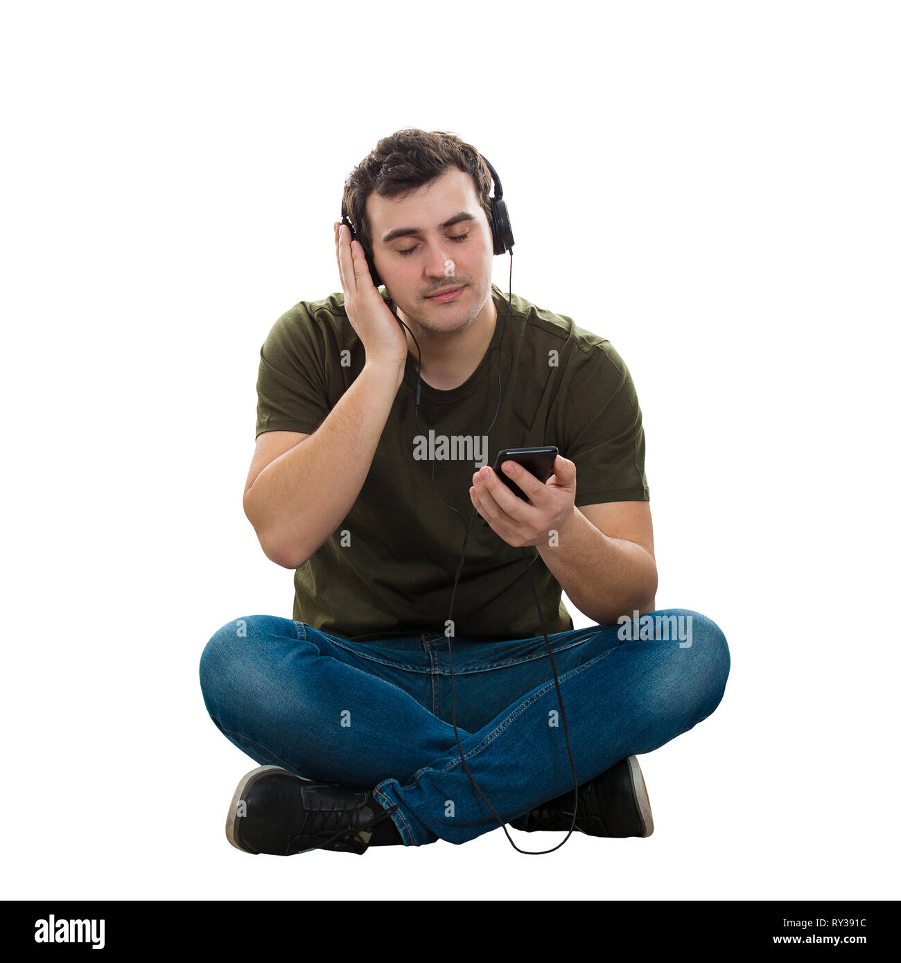 Relaxed casual guy sitting on the floor listening calming music on ...
