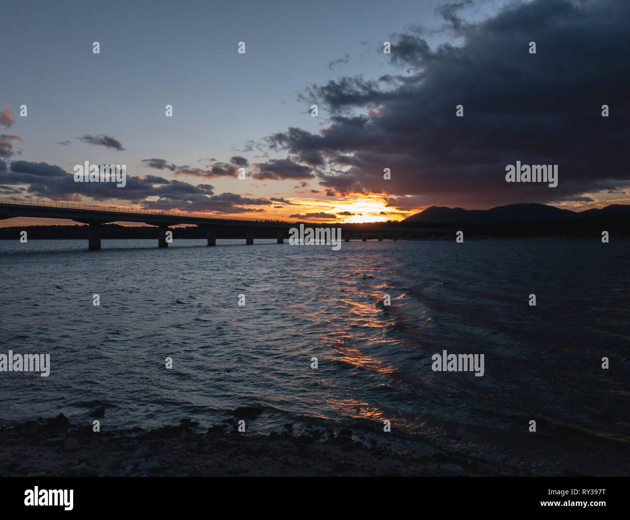 Nice sunset behind the waters of a lake Stock Photo - Alamy