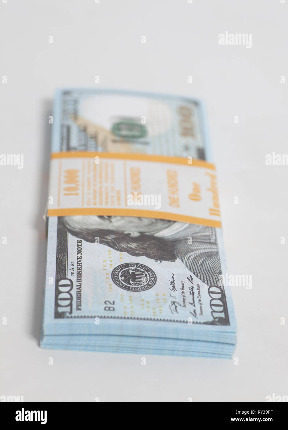 Stack one hundred dollars bills with tape isolated on white background ...
