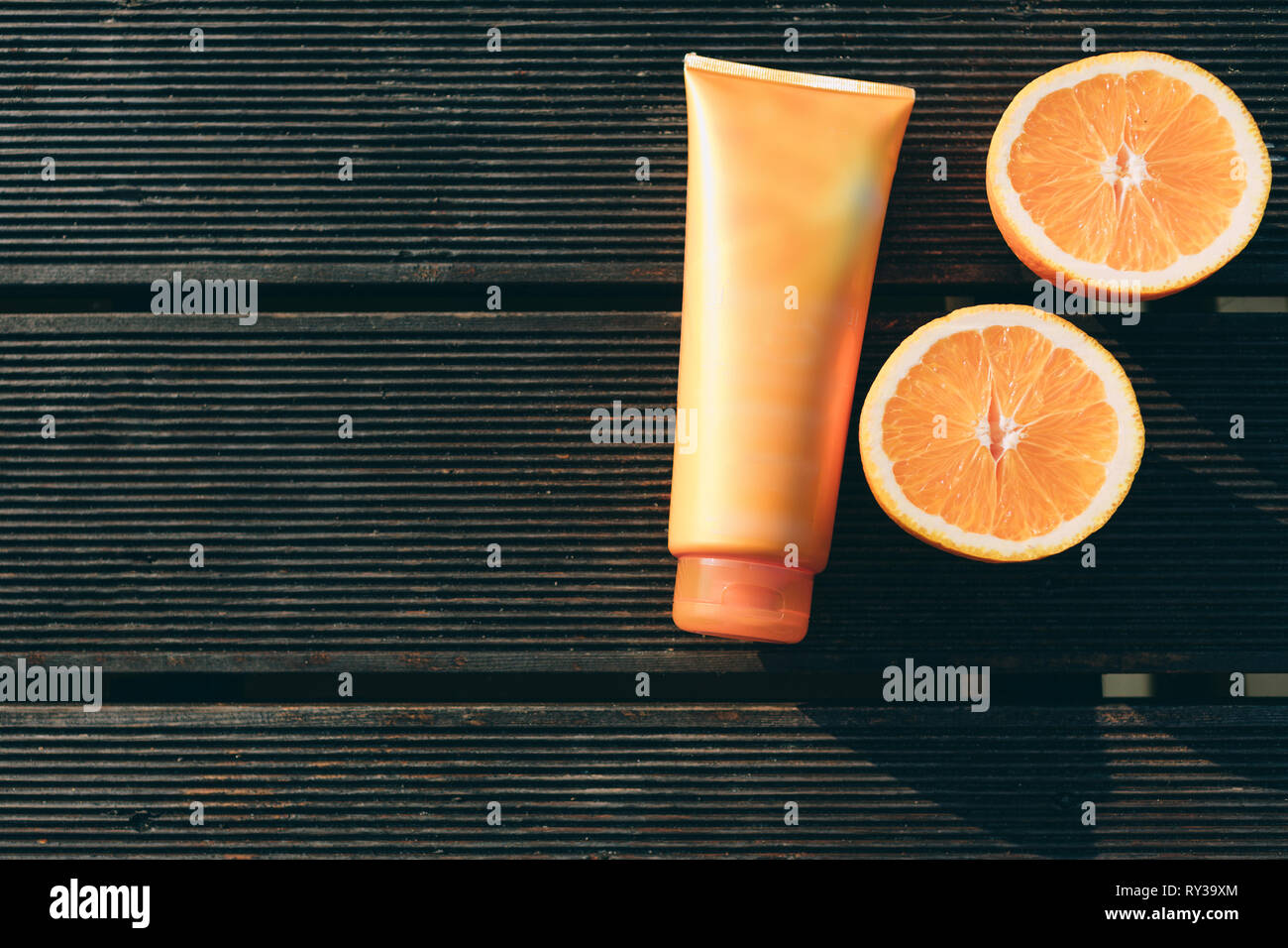 Sunblock cream and citrus on wood background. Summer concept. Orange ...