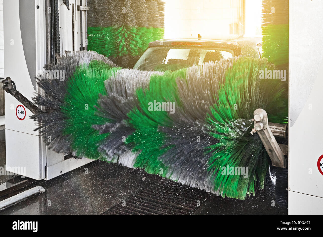 Automatic indoor car wash service in action Stock Photo - Alamy