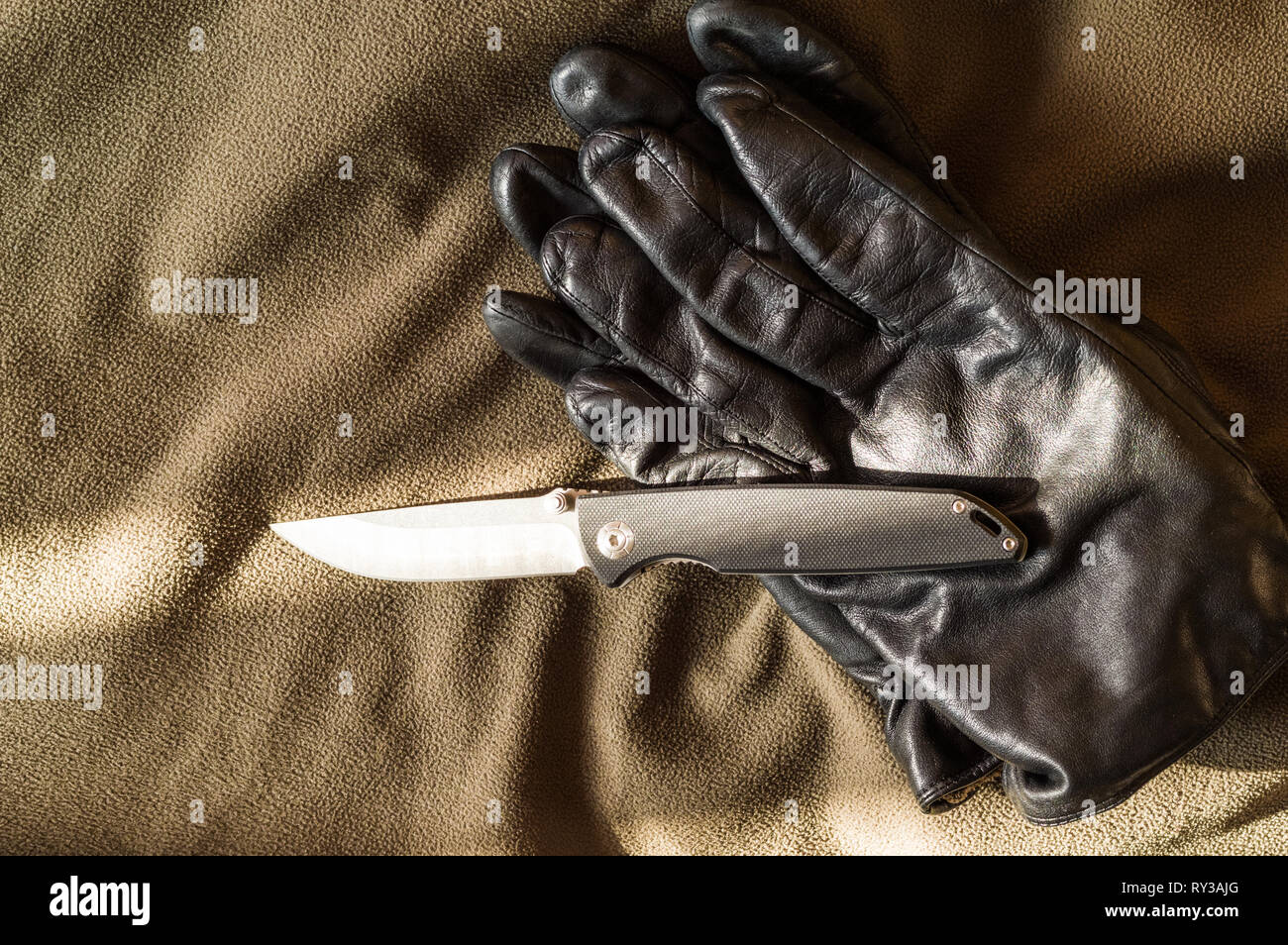 A sun glare on the blade of a knife. Light on the knife from the window ...