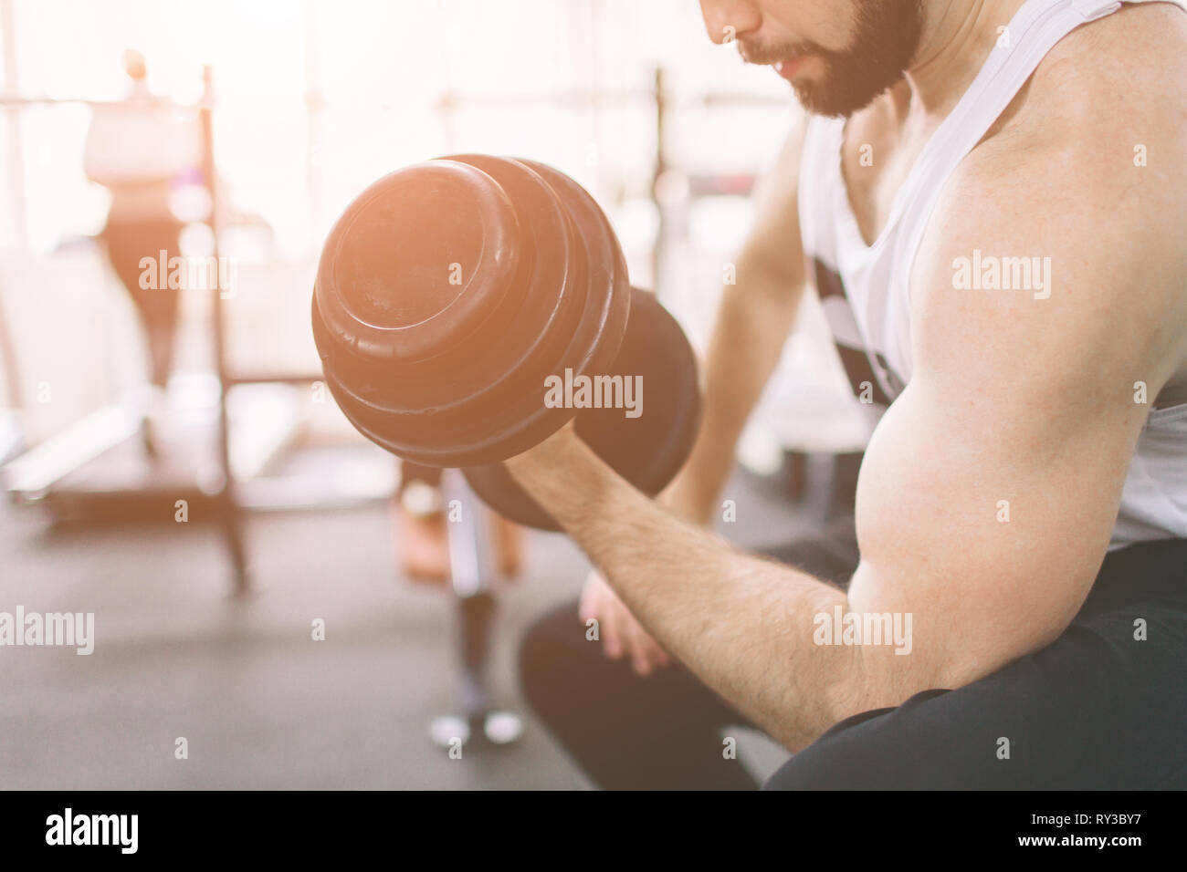 Muscular Bearded man during workout in the gym. Athlete muscular ...
