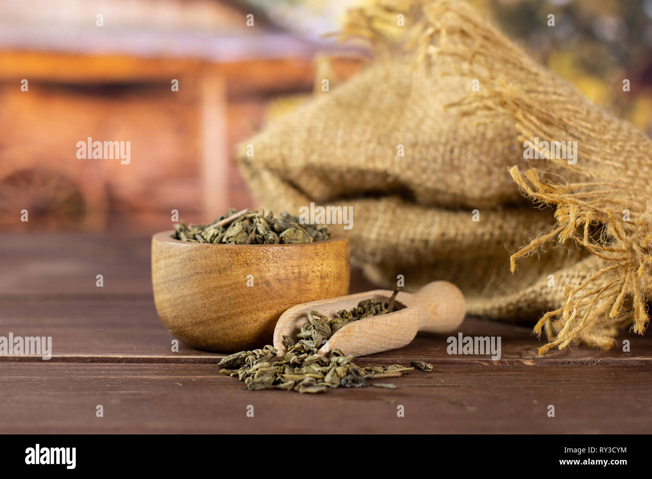 Lot of pieces of dry green tea with wooden bowl in a country yard Stock ...