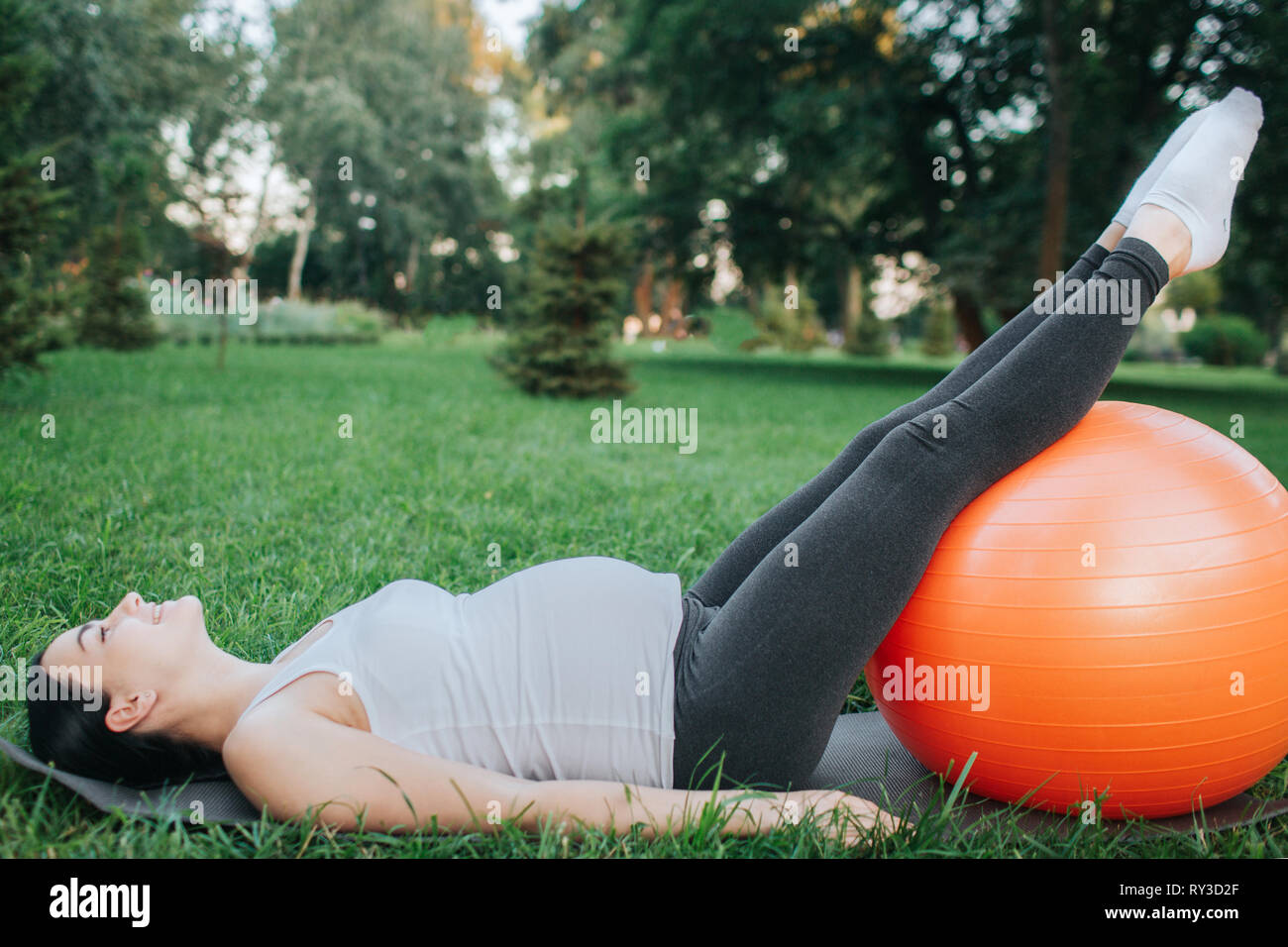 Woman lying on back legs up hi-res stock photography and images - Alamy