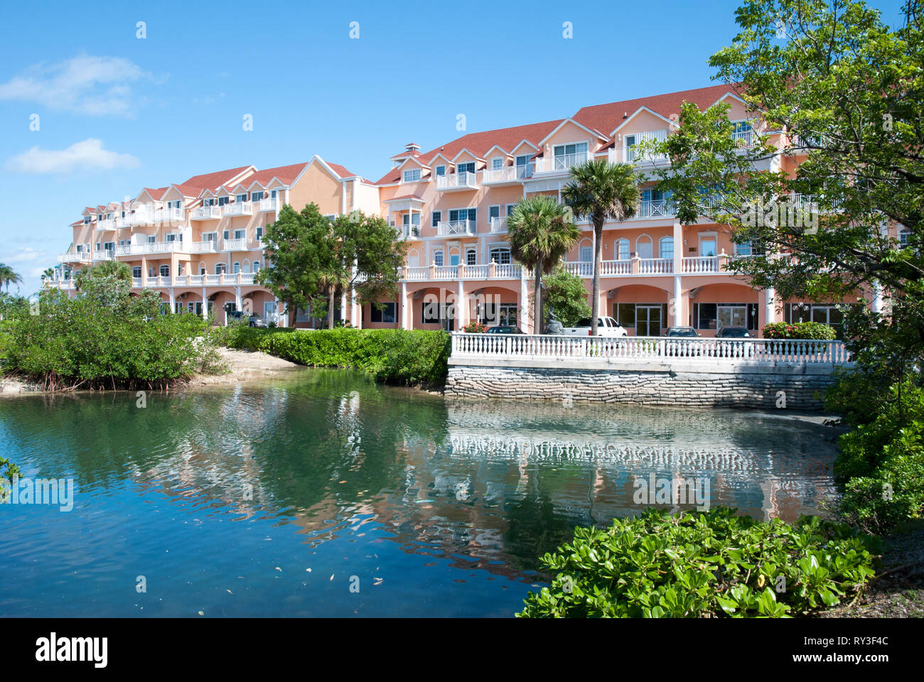 The pond with reflections in Sandyport village, the resort district in ...
