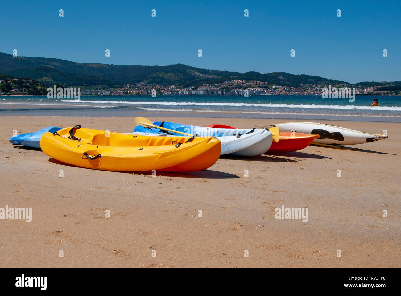 Kayak and canoes on beach in blue ocean waters landscape Stock Photo ...