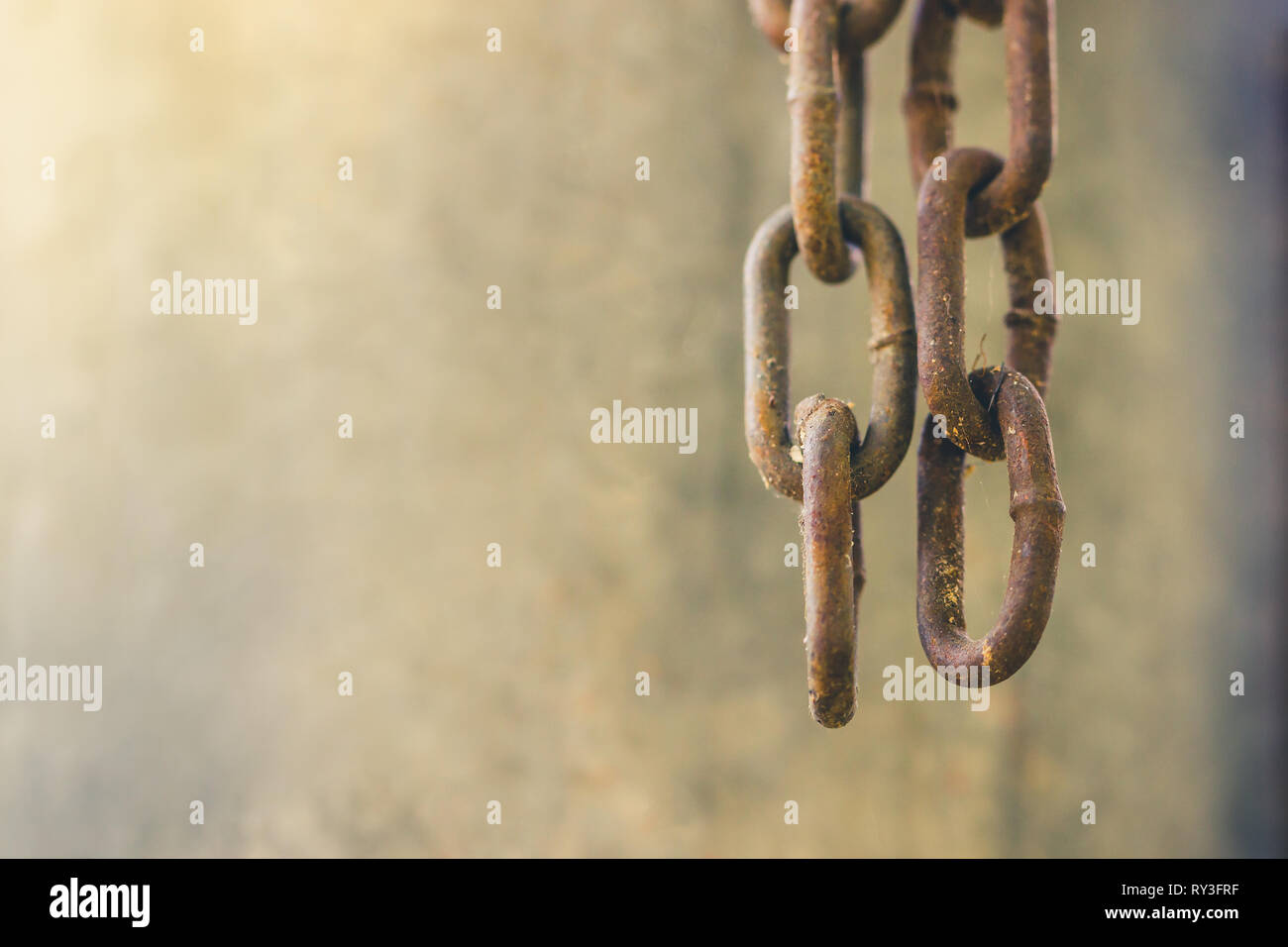 Two old rusty chains were hanging down from above, Beside the wall ...