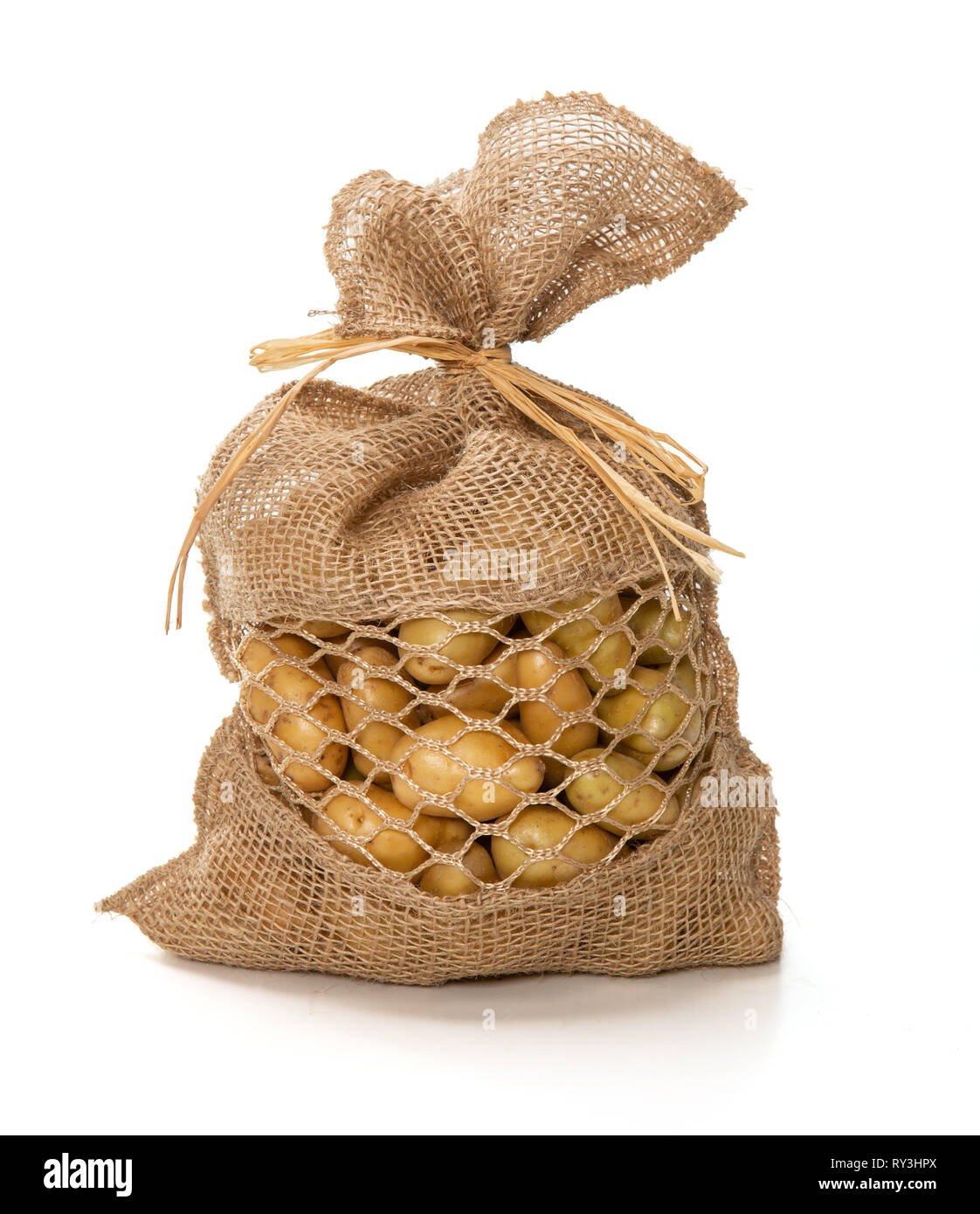 Small potato in a pretty jute bag on a white background Stock Photo - Alamy