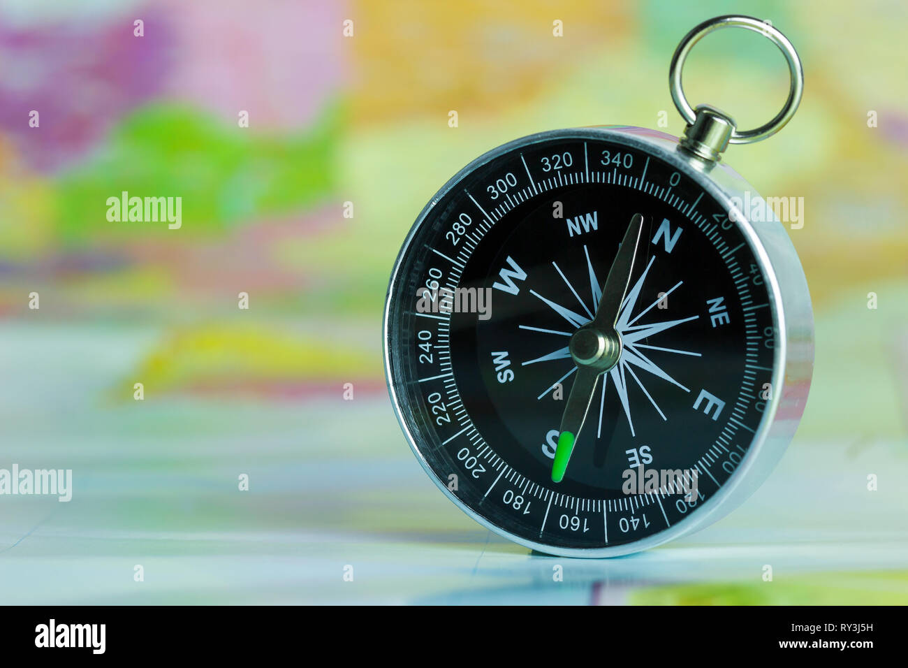Compass laid on a paper map. The concept of travel Stock Photo - Alamy