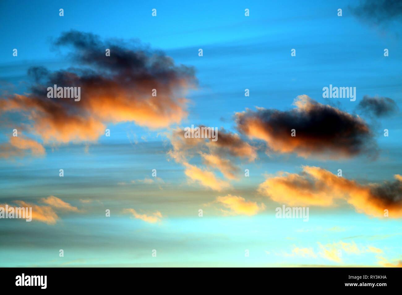Fine macro photo of flying pink clouds on blue sunset sky Stock Photo ...