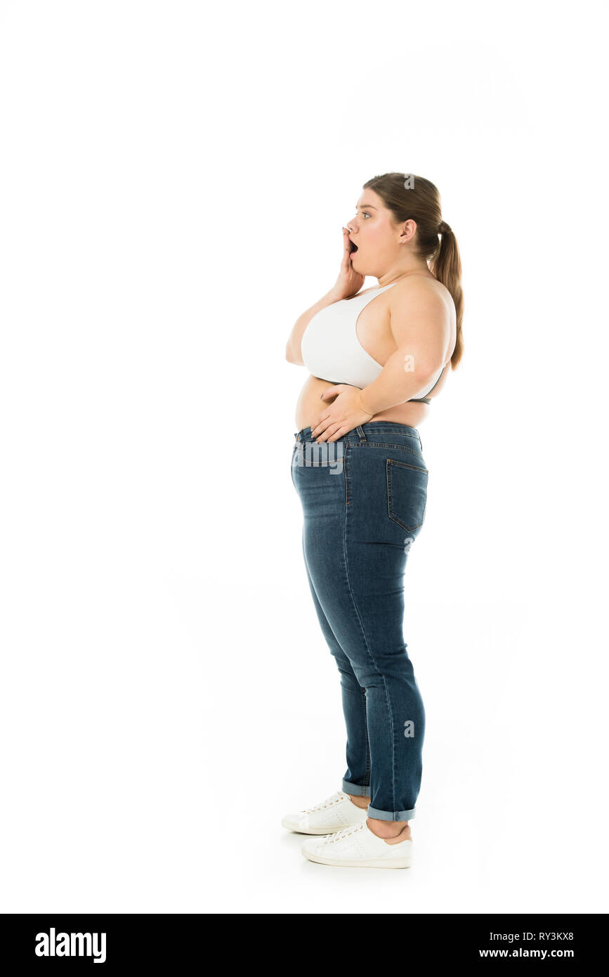 side view of shocked overweight woman in denim isolated on white Stock ...