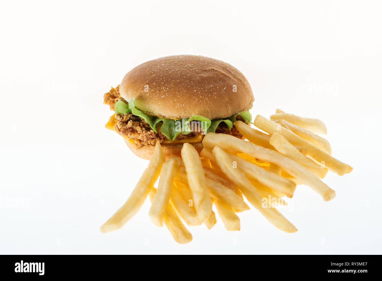 tasty unhealthy chicken burger near french fries isolated on white ...
