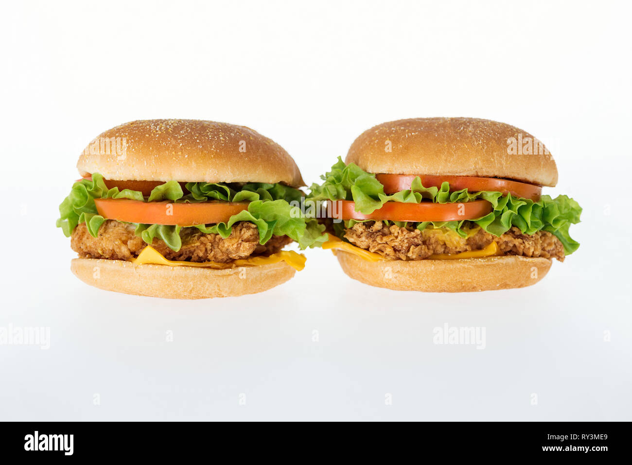 delicious unhealthy chicken burgers isolated on white Stock Photo - Alamy