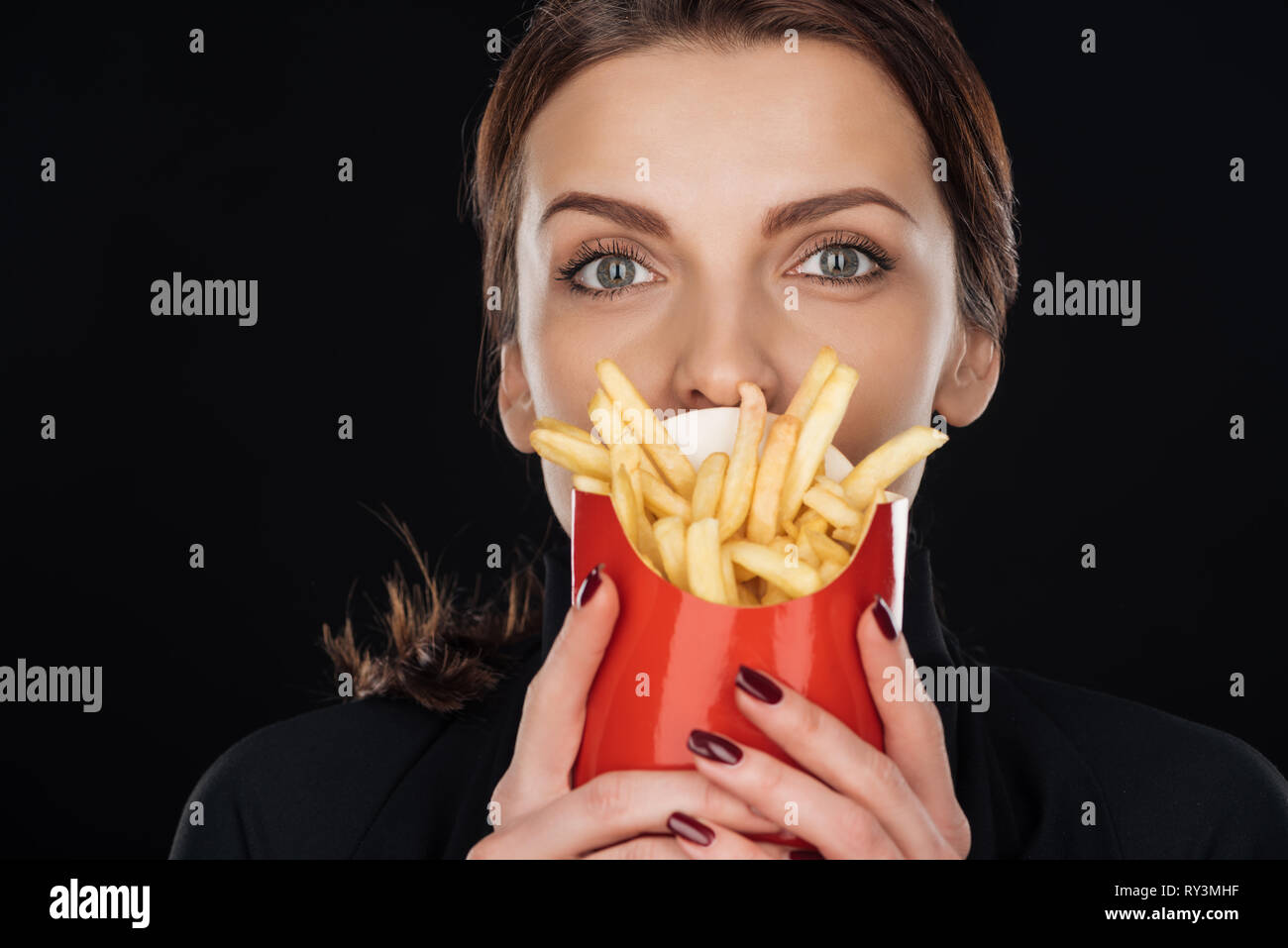 Woman french fries looking at camera hi-res stock photography and ...