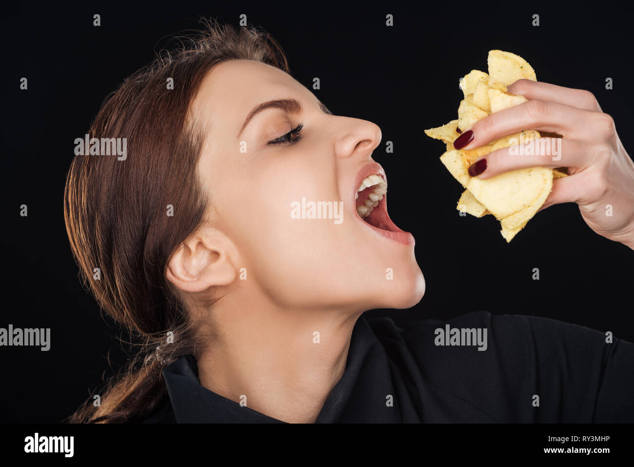 Attractive woman eating chips hi-res stock photography and images - Alamy