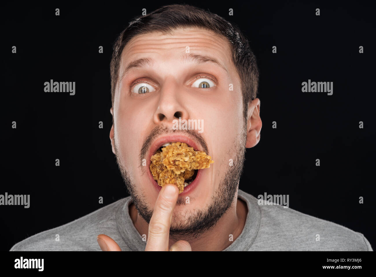 Man putting food to mouth hi-res stock photography and images - Alamy