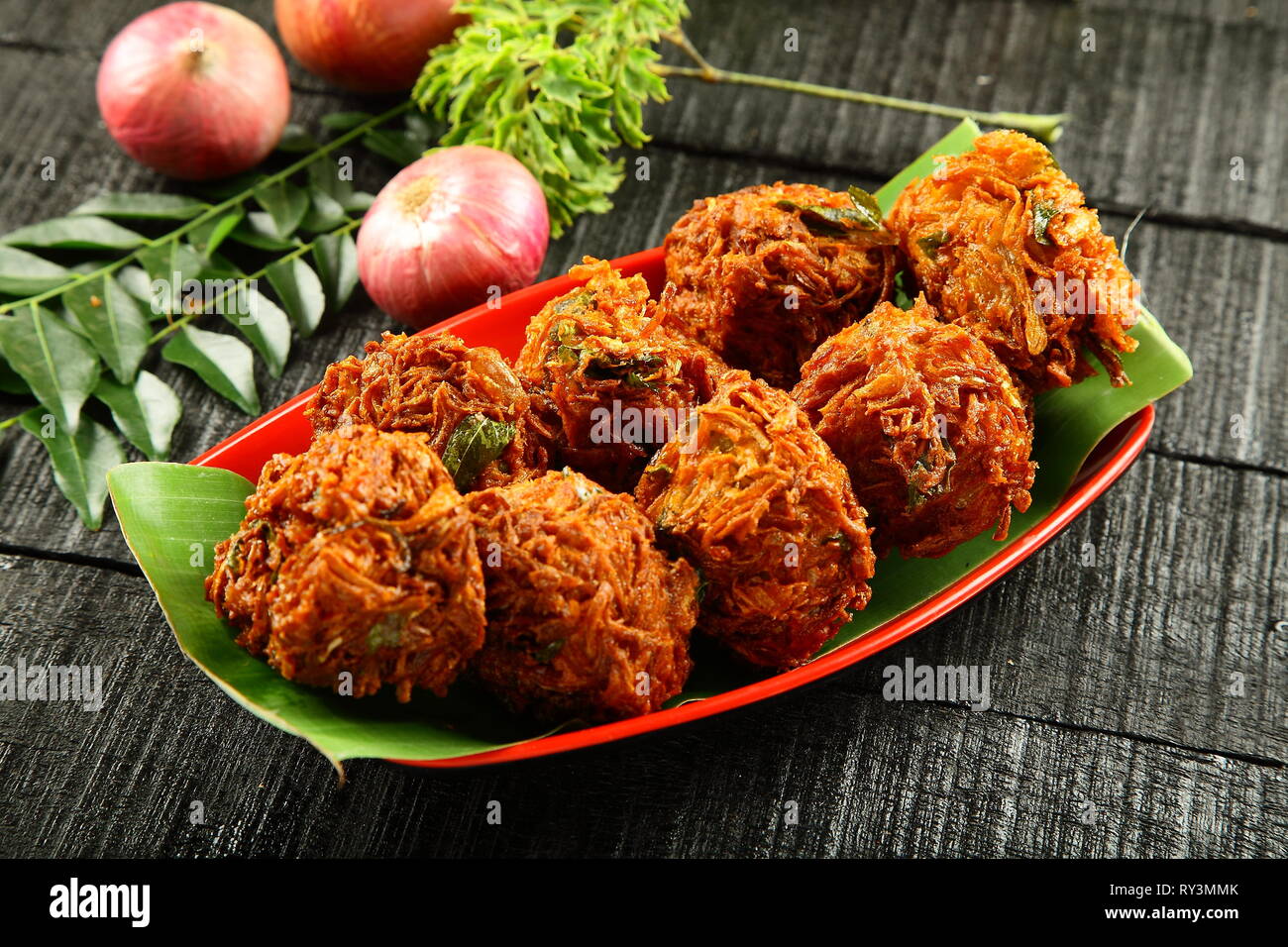 Indian cuisines- crispy fried onin fritters , ulli vada, pakkoda ...