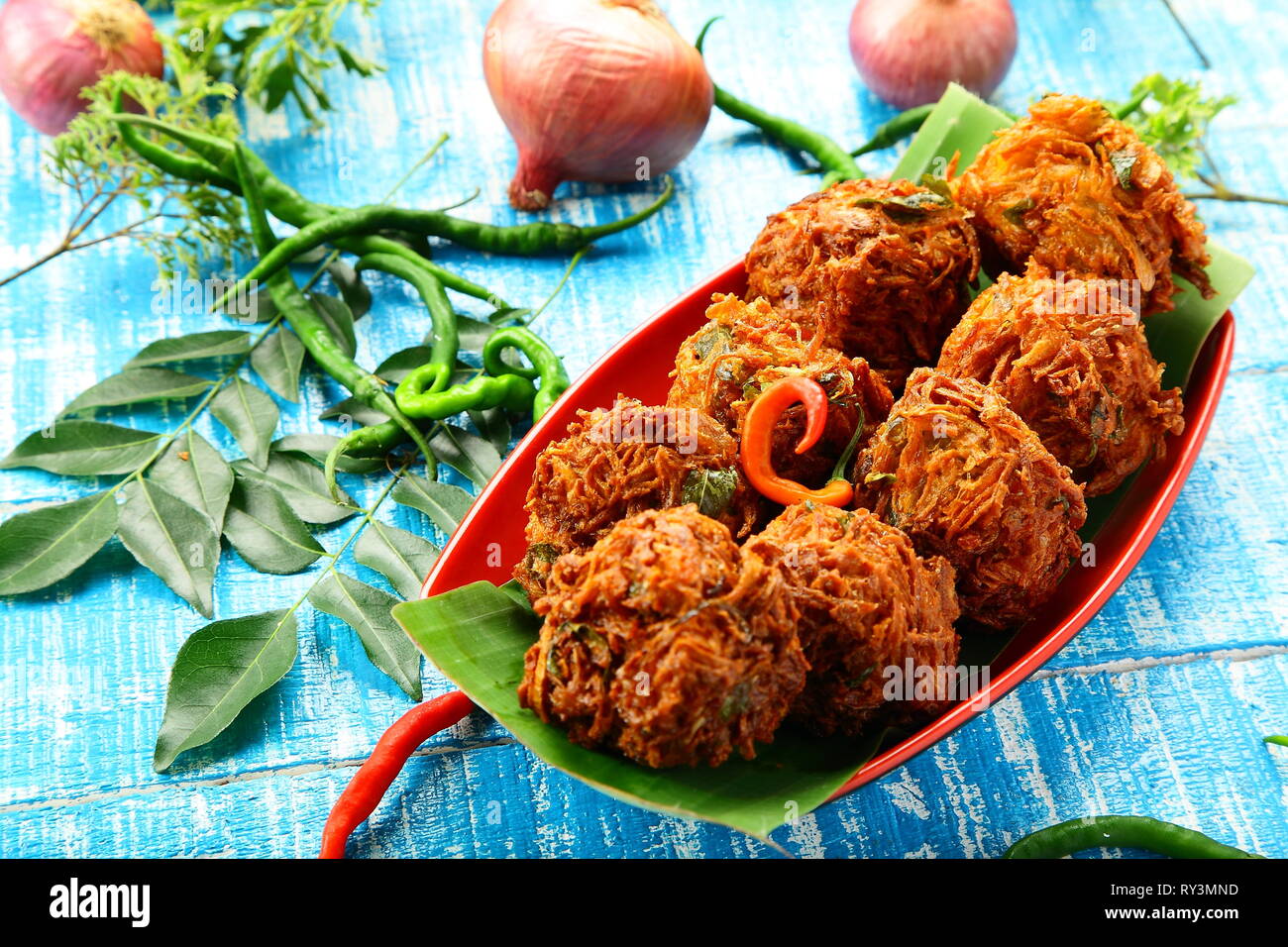 Indian cuisines- crispy fried onin fritters , ulli vada, pakkoda ...