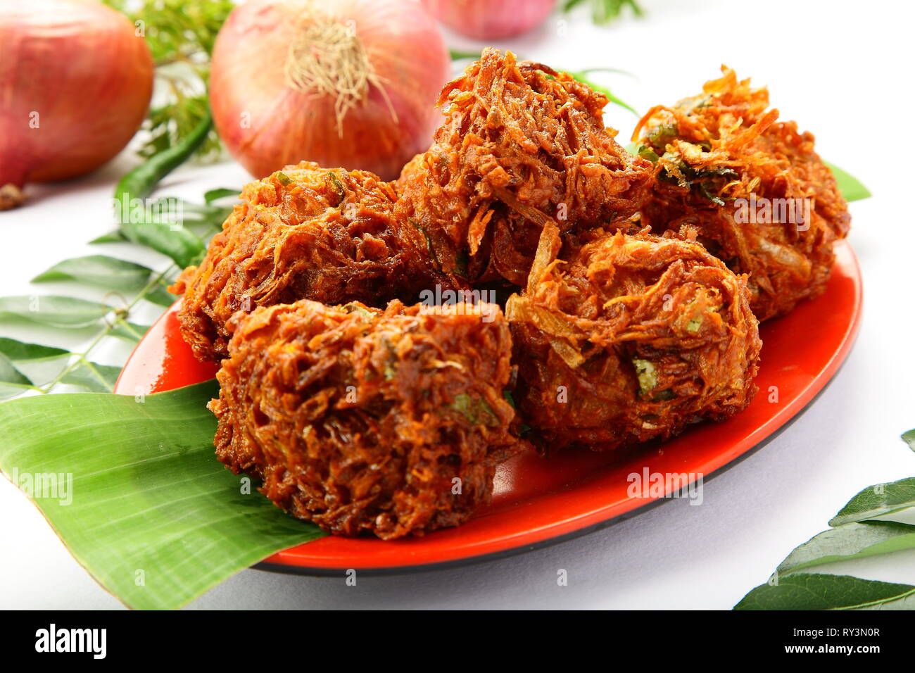 Spicy crispy fried onion fritters , ulli vada, pakora,pakoda, Indian ...