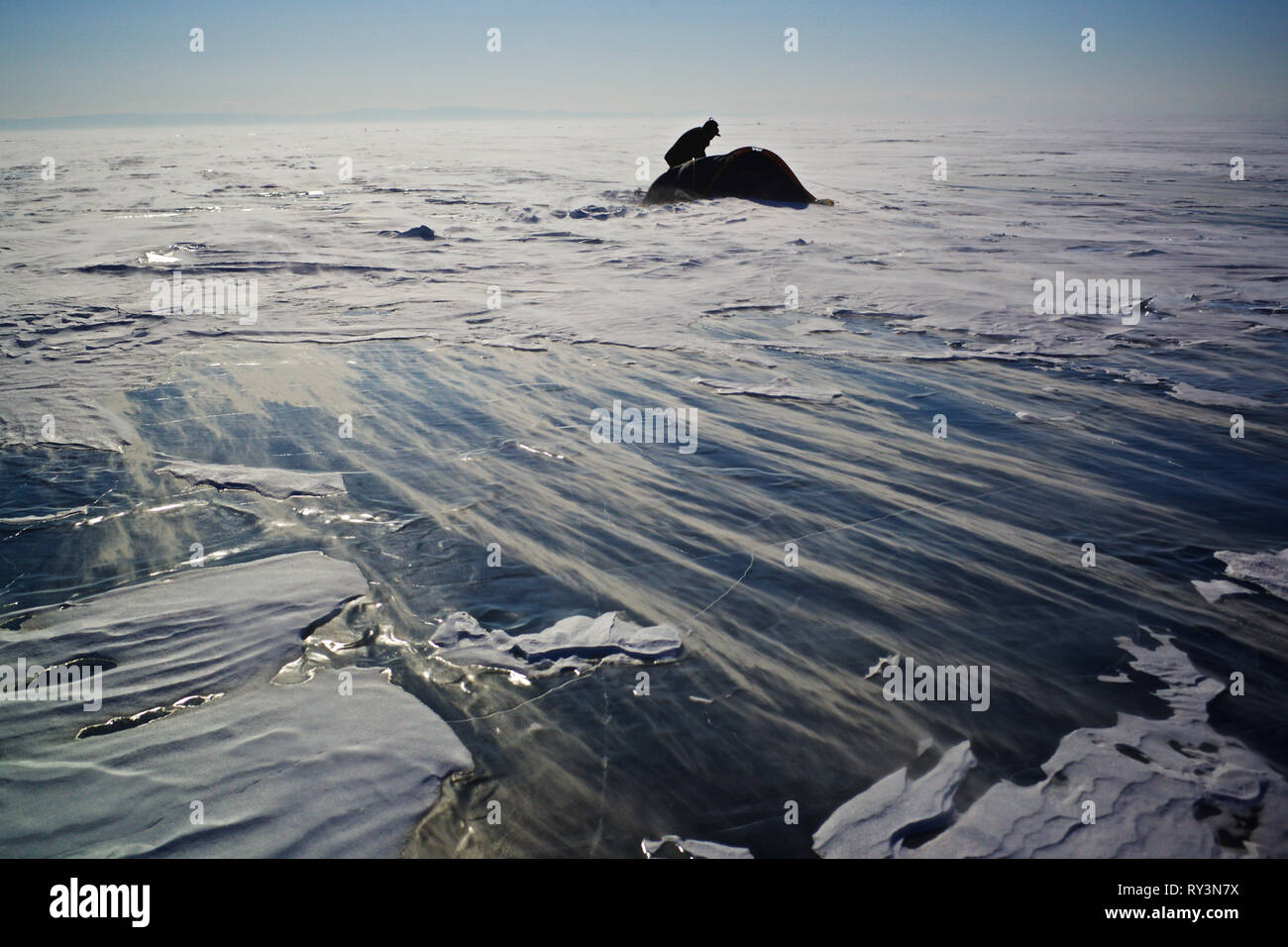 Russian man ice camping in storm, Olkhon Island, Baikal Lake, Buryat ...